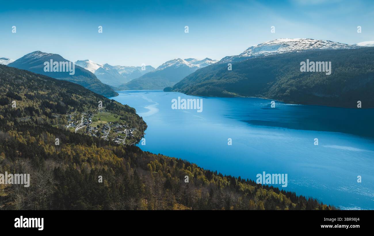 Aerial view of the deep blue fjord snaking between steep, forested ...
