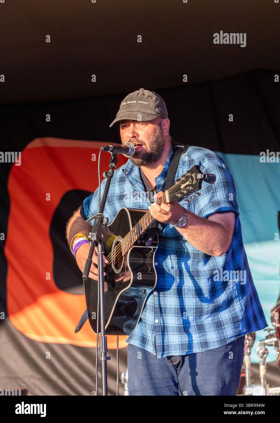 Sticky Bones Jones a local artist playing live on stage at the 2025 ...