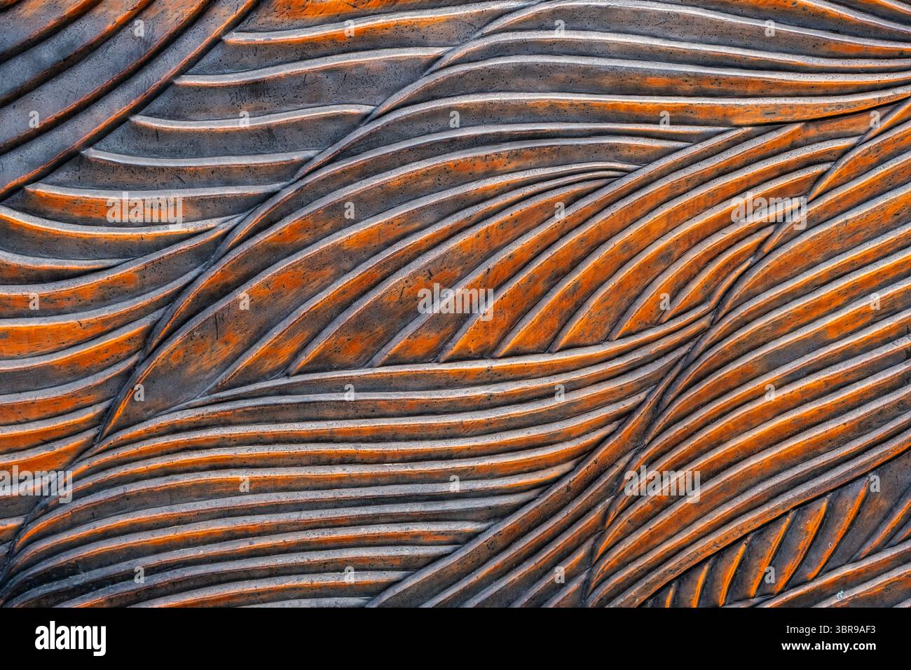 a textured metal surface featuring wavy, ribbed patterns. The metal has ...