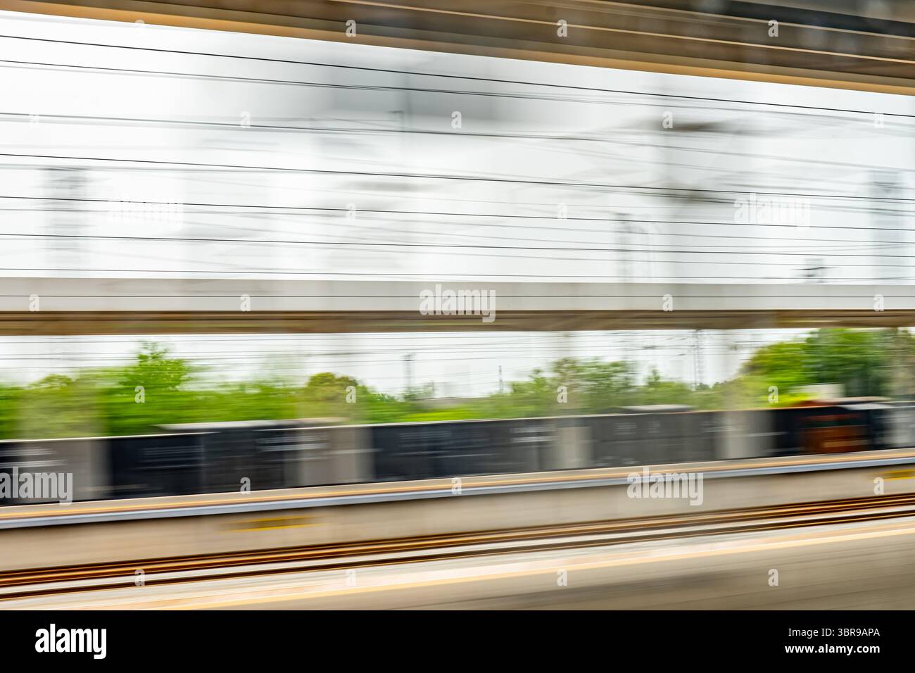 Dynamic motion blur view from high-speed train window: Green landscape ...