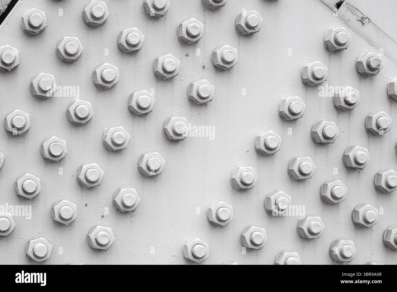 steel beams is bolted down. Close-up shows the connection of the metal ...