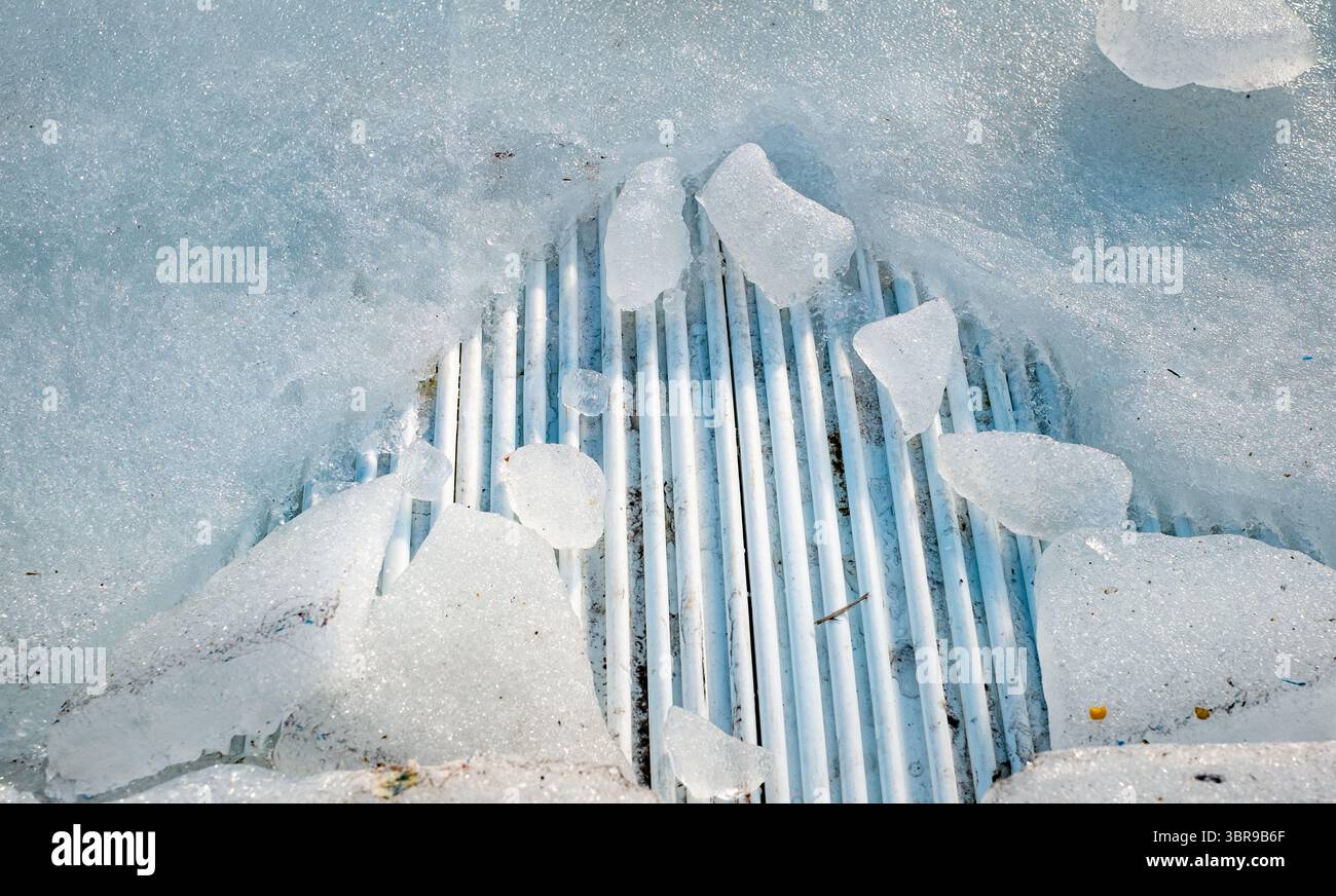 melted ice on the rink, freon pipes visible Stock Photo - Alamy