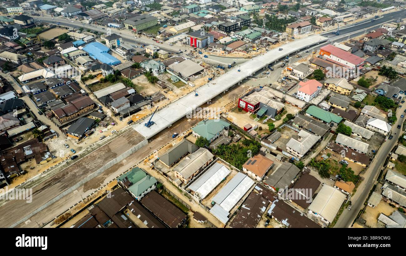 Aerial view of a new concrete highway cutting through a dense urban ...