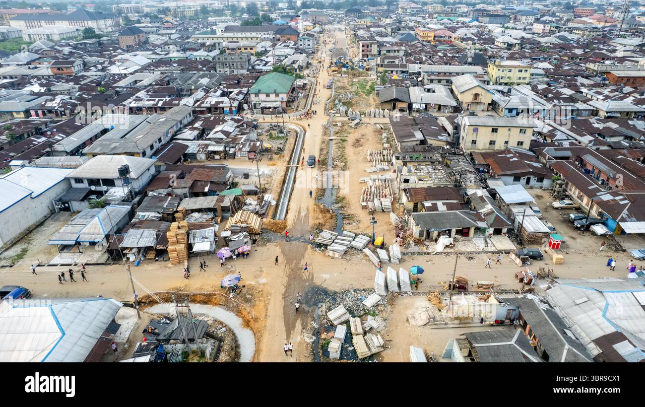 Aerial view of a bustling cityscape, where a new road cuts through ...