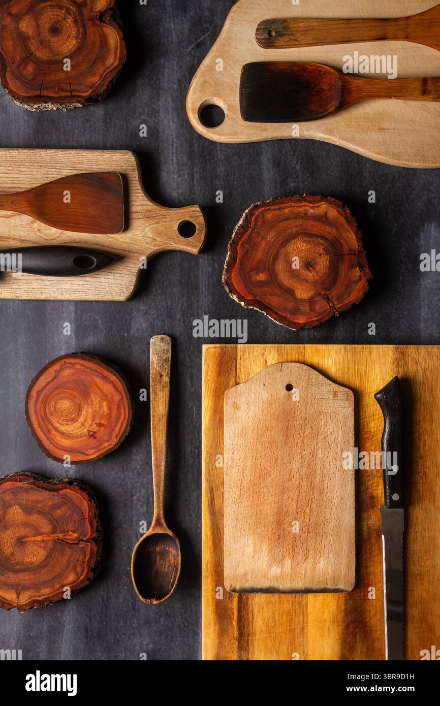 Wood log tree slices and cutting boards on black chalkboard. Flat lay ...