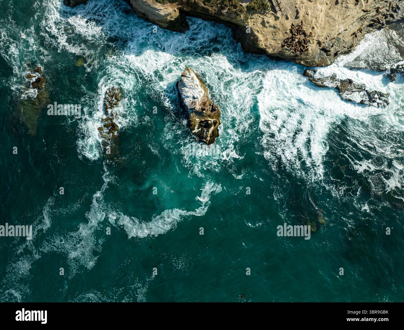 Aerial view of the rugged coastline where cliffs meet the azure ocean ...