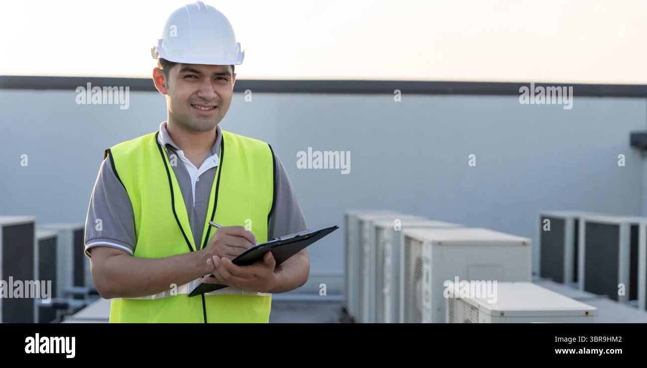 Portrait Asian maintenance engineer works on the roof of factory ...