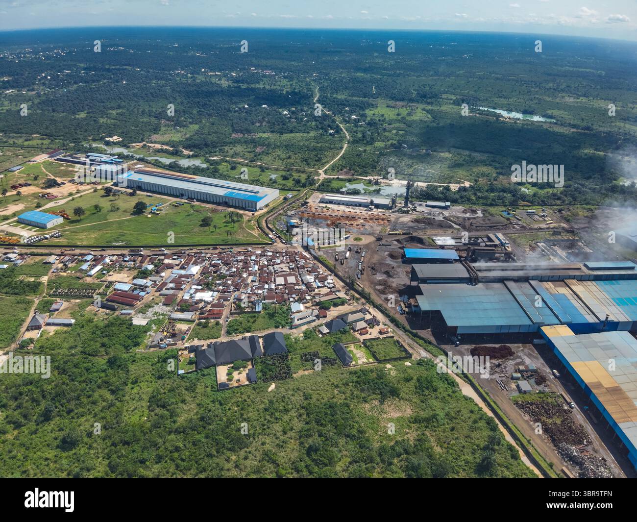 Aerial view of industrial buildings juxtaposed with residential areas ...