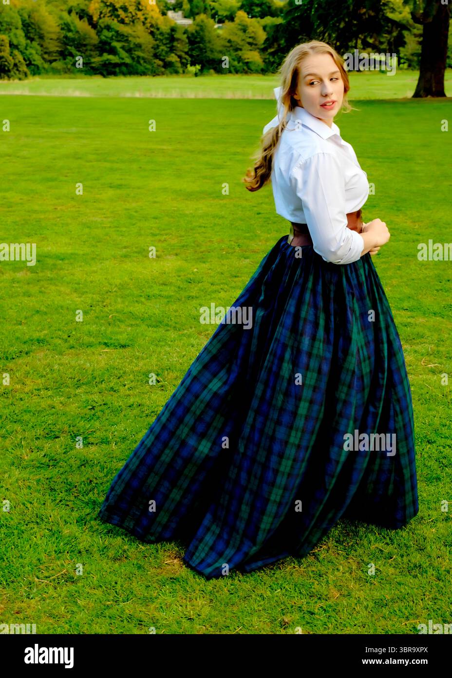 A woman in a white shirt, brown belt, and long plaid skirt stands on a ...