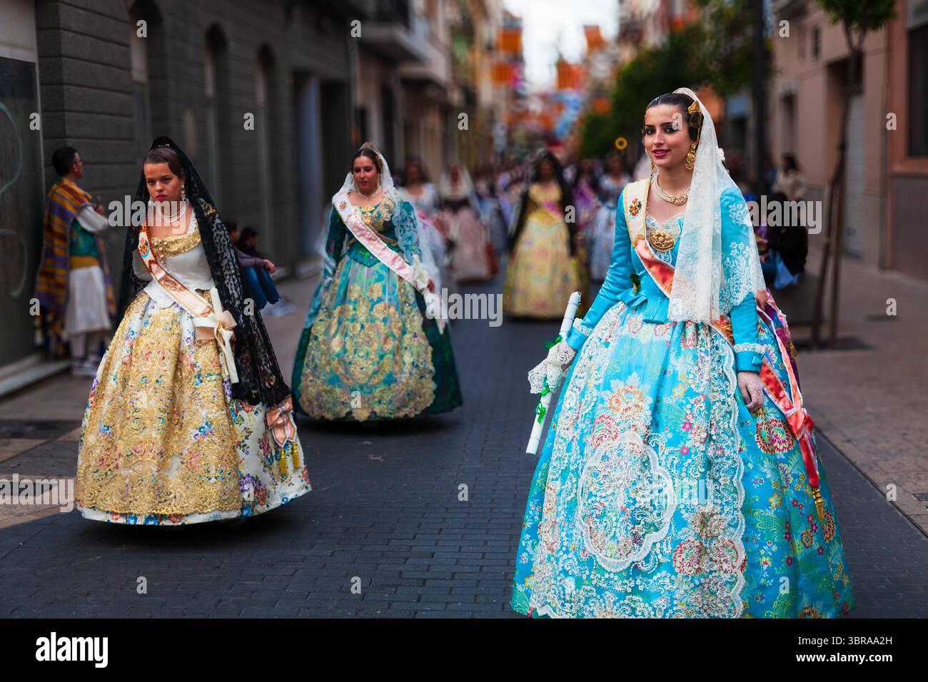 Falles in Gandia Spain procession with falleros and falleras dressed in ...