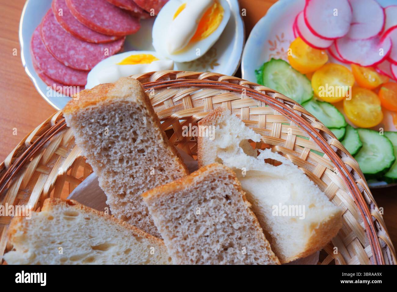 Tasty breakfast features slices of bread, boiled eggs, and vibrant ...