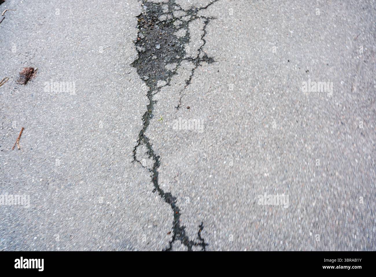A deep crack in asphalt illustrates the power of nature over human ...