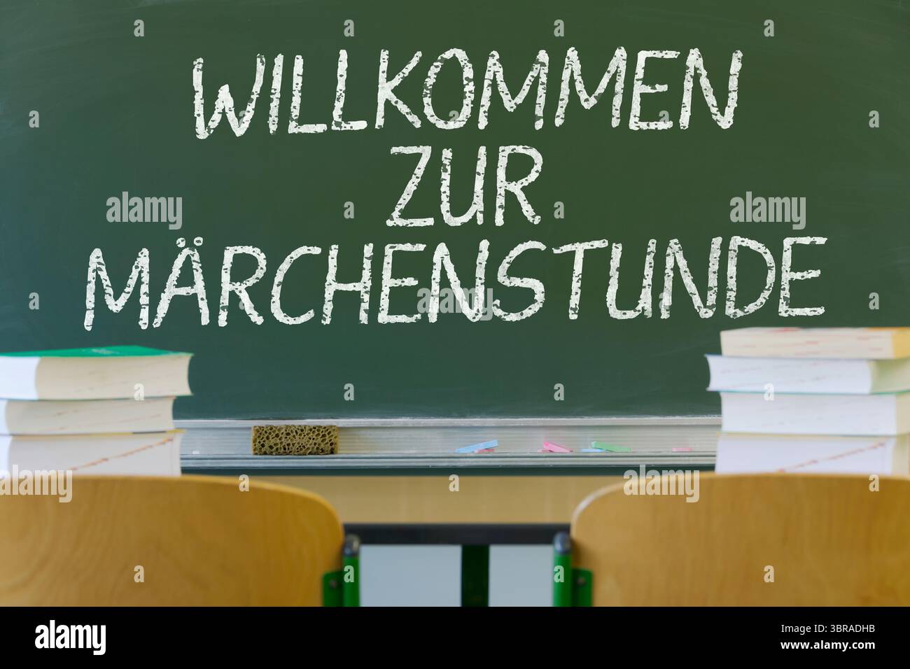 Chalkboard in the classroom with German chalk writing "Willkommen zur ...