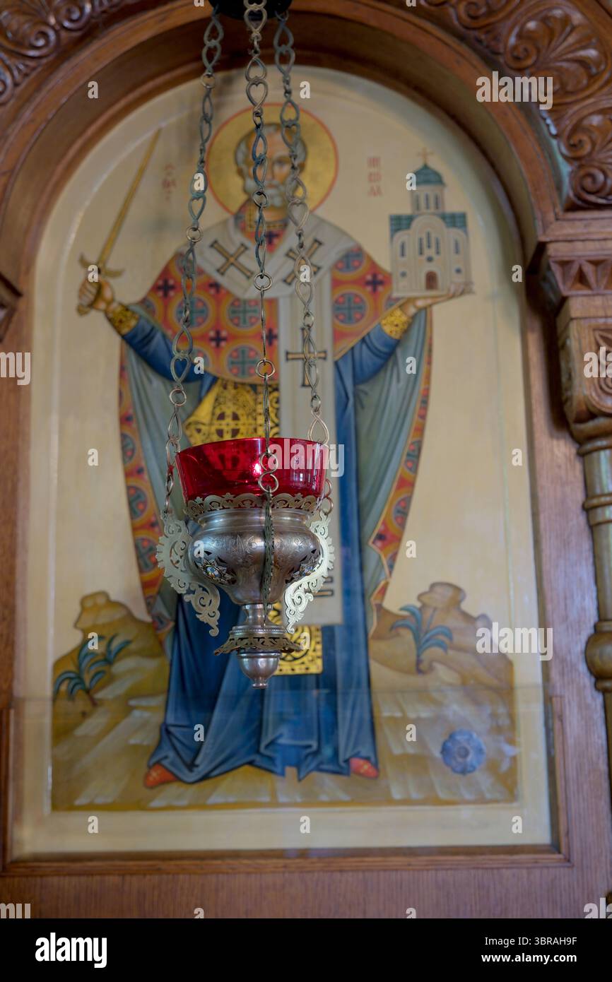 A stunning mural features a saint with faith symbols and elegant decor ...