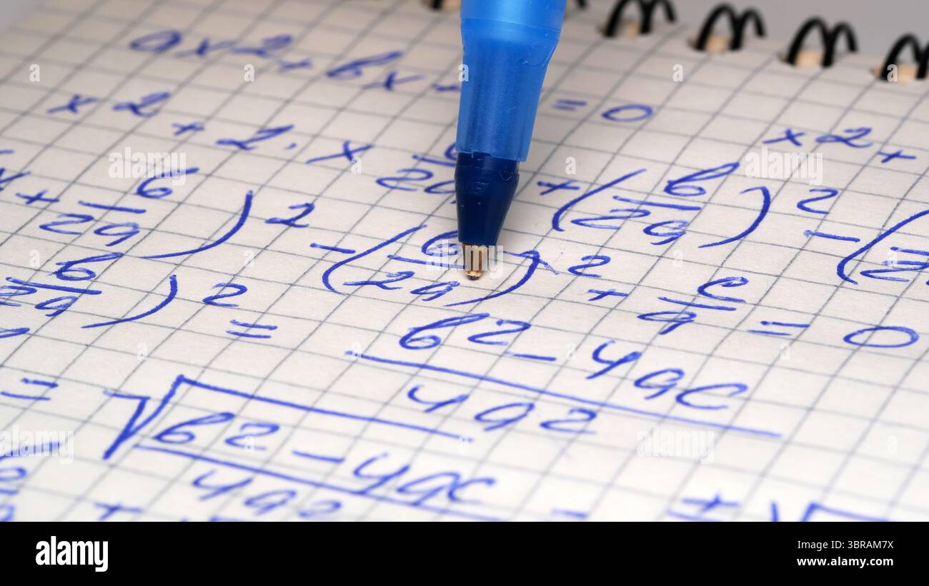 Detailed calculations fill graph paper with pens in a study setting ...