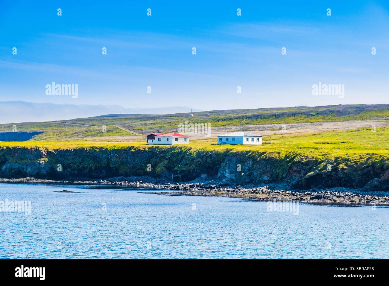 Atlantic ocean shore on northern Iceland, houses in small town of ...