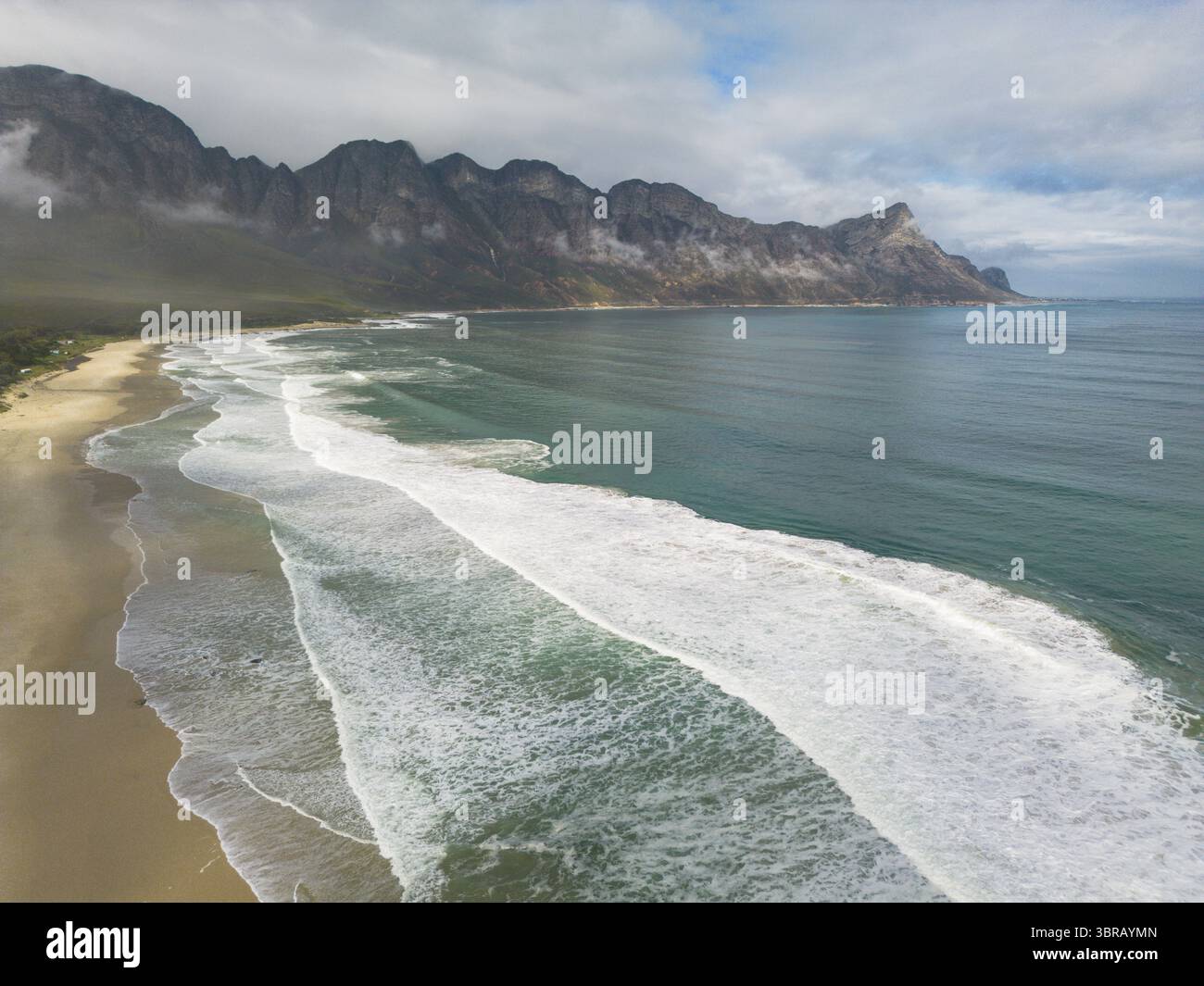 Aerial view of where the sandy beach meets the turquoise ocean, framed ...