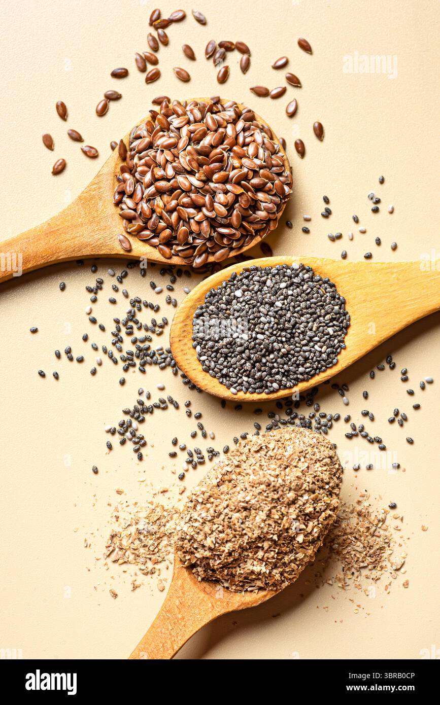 Flaxseeds, chia seeds and bran ground on spoons. Healthy eating ...