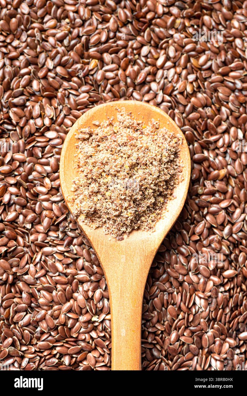 Flaxseeds as background and ground of flax seeds on wooden spoon, top ...