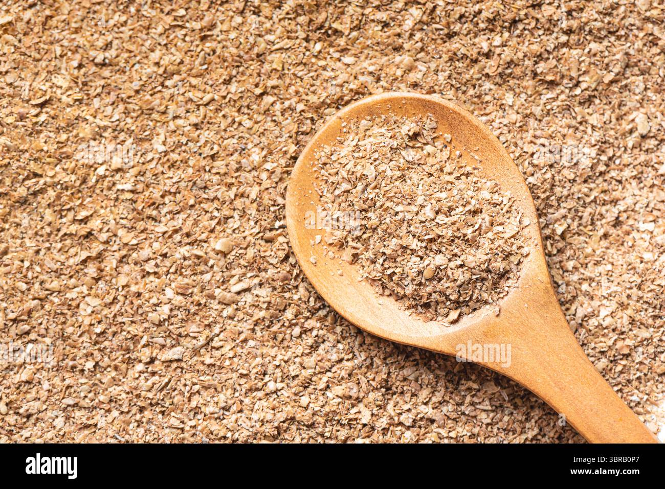 Wheat bran fiber in spoon and as background, copy space. Detailed ...