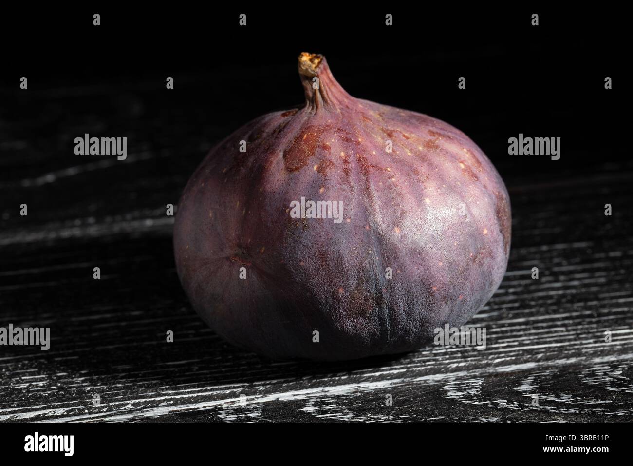 figs fruit on black wood background Stock Photo - Alamy