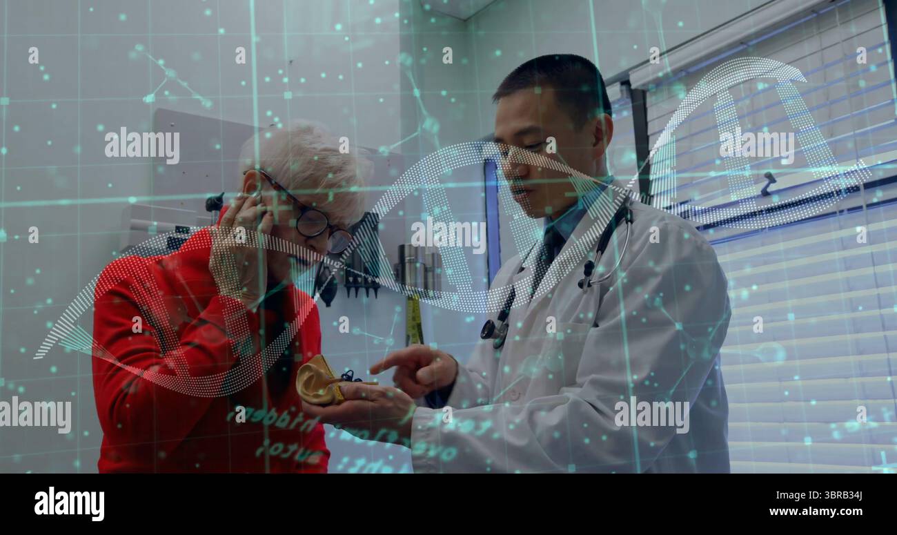 Pointing Asian doctor explaining prosthetic ear use to senior patient ...