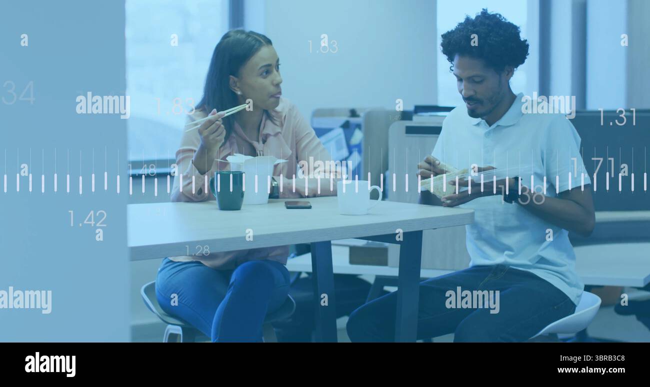 Colleagues eating takeout lunch with chopsticks at office break area ...