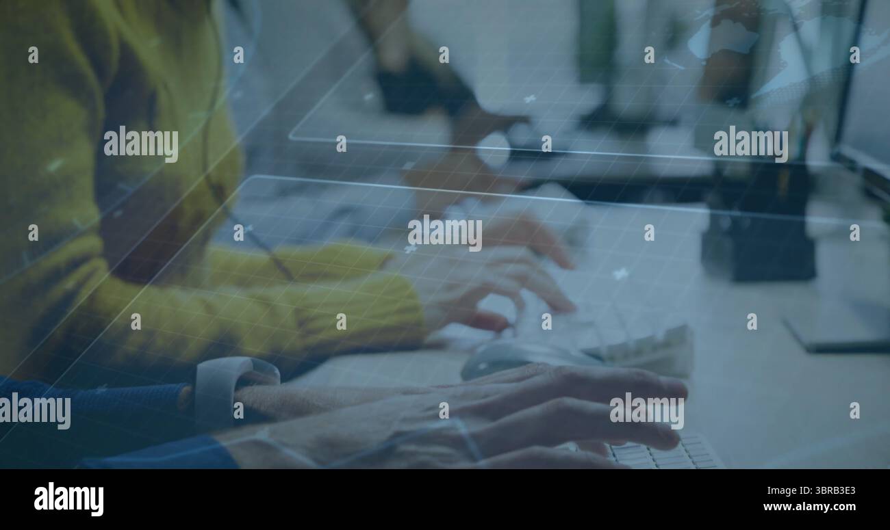 Typing hands in sweater sleeves on keyboards in open-plan office, with ...