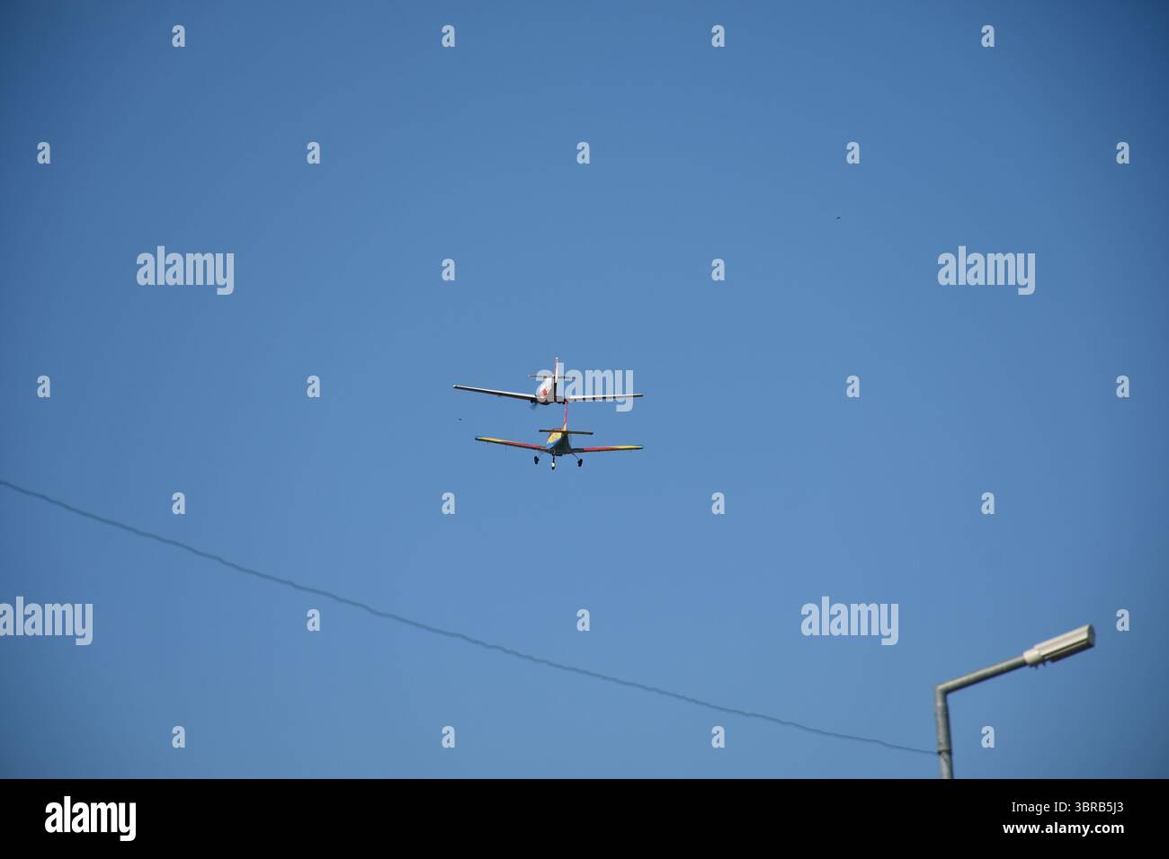 Two aerobatic aircraft fly in a stacked vertical formation during an ...