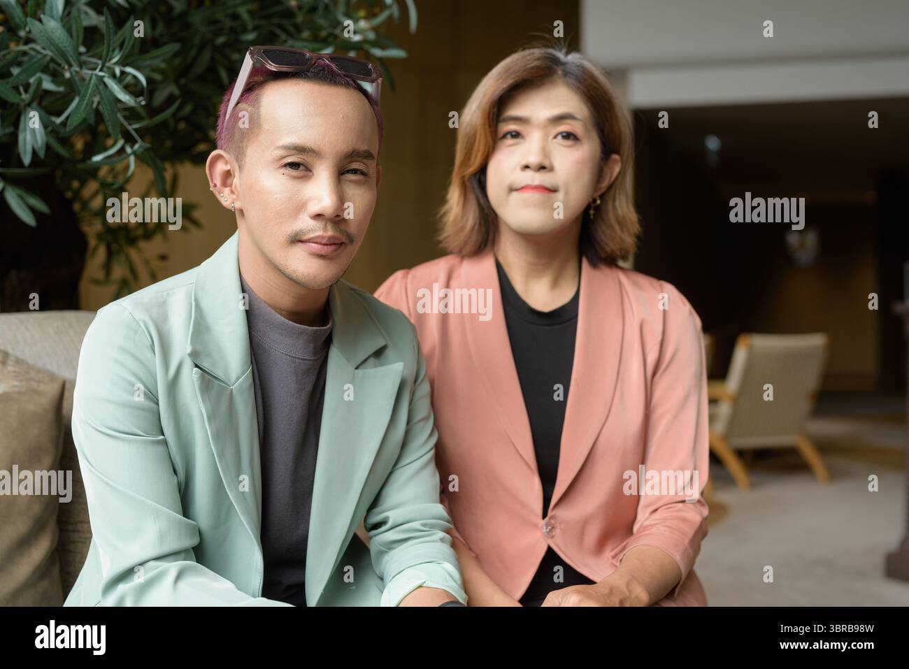 Asian transgender woman and non-binary coworkers working remotely in ...