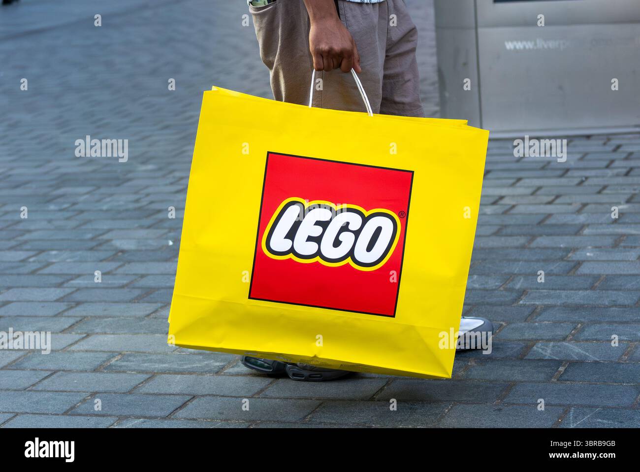 Close up of a person holding a Lego store shopping bag in Liverpool ...