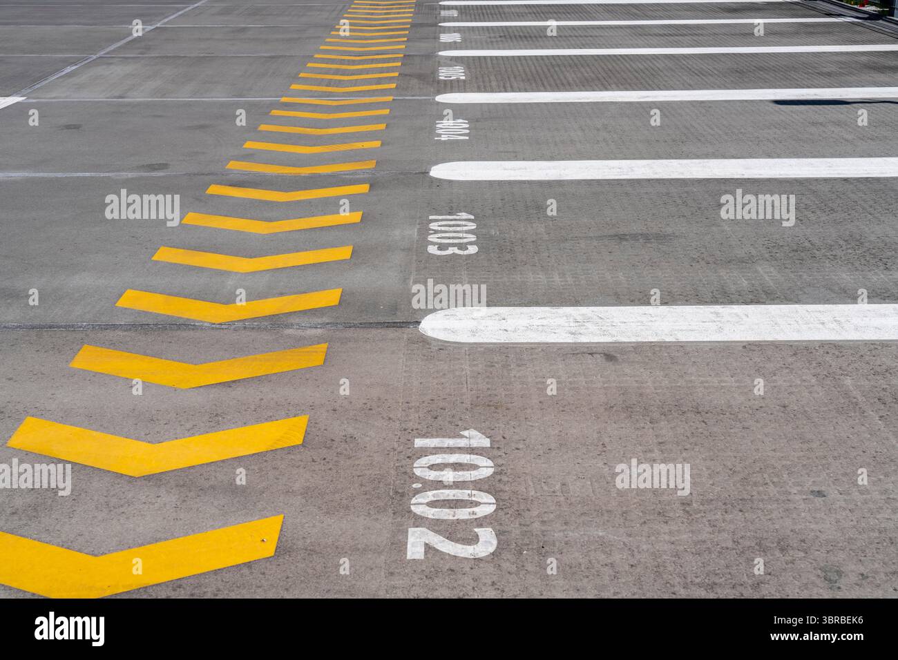 Markings on a parking deck, direction of travel markings, numbered ...