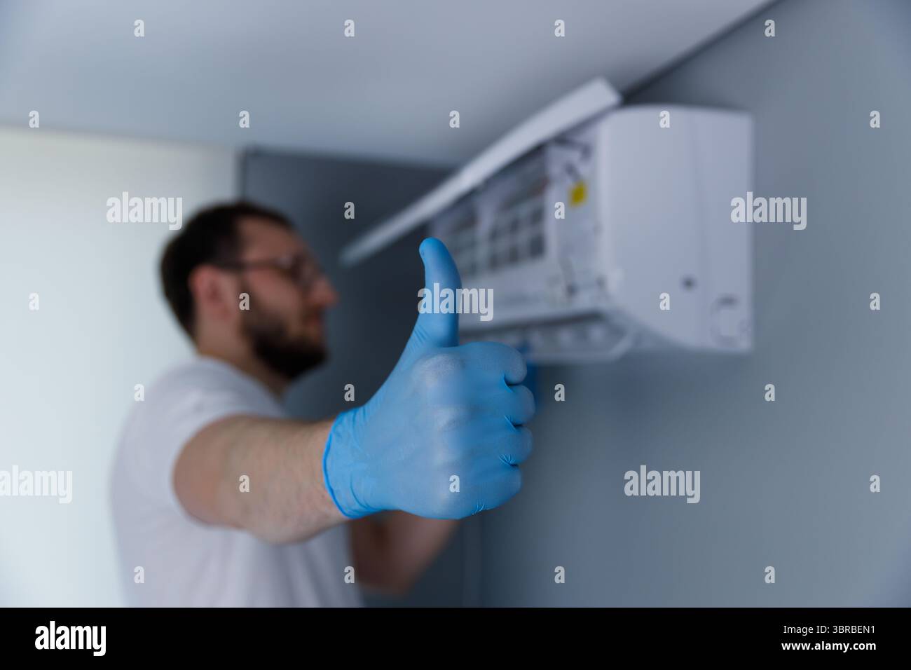 Skilled Technician Giving Approval After Successfully Installing a New Air Conditioning Unit for ...