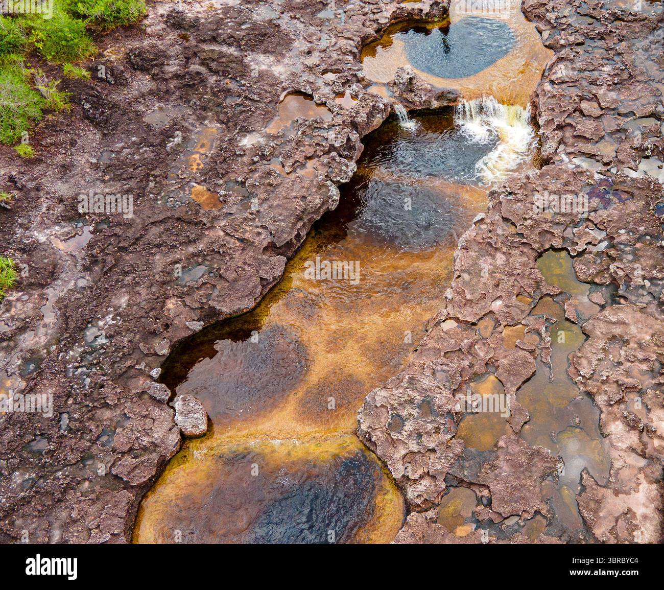 Aerial view of striking rock formations with natural water pools in ...