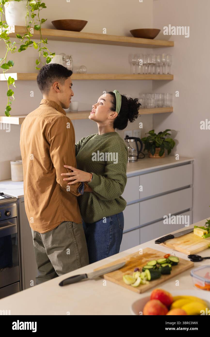 Diverse couple hugging hanging hi-res stock photography and images - Alamy