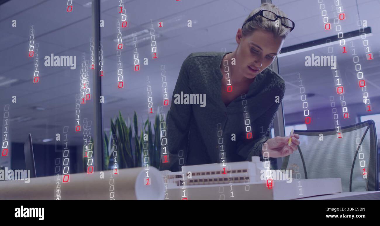 Leaning architect inspecting scale model at office desk with blueprints ...