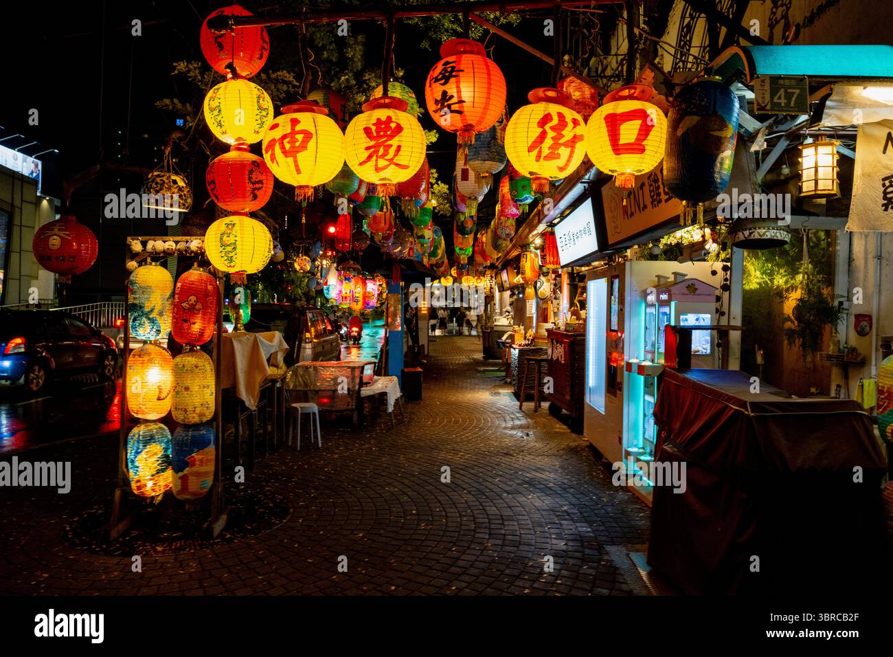 Tainan, Taiwan – Jun 29 2025: A vibrant evening view of Shennong Street Entrance, illuminated by ...
