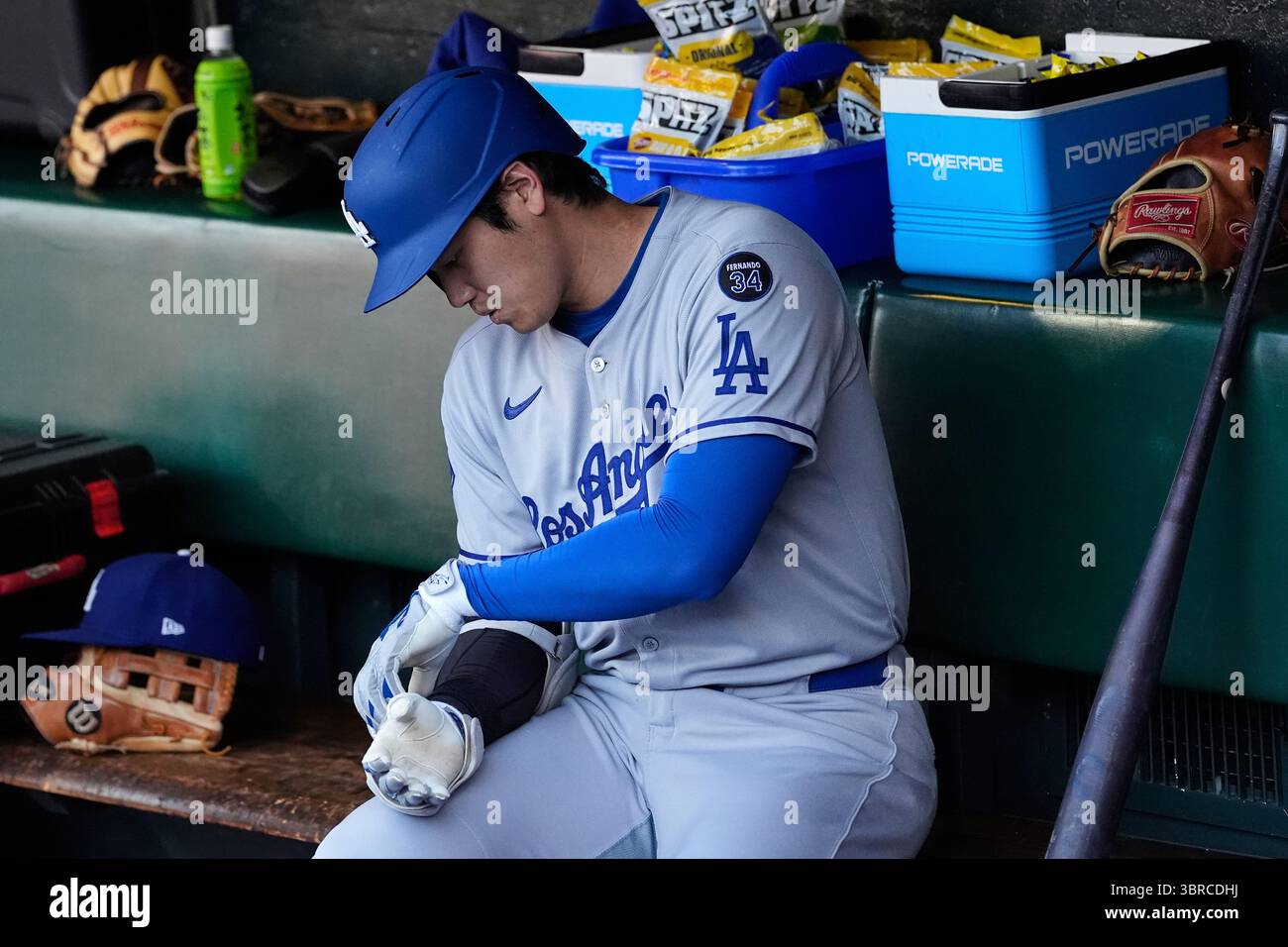 Los Angeles Dodgers' Shohei Ohtani gets ready to bat in the dugout ...