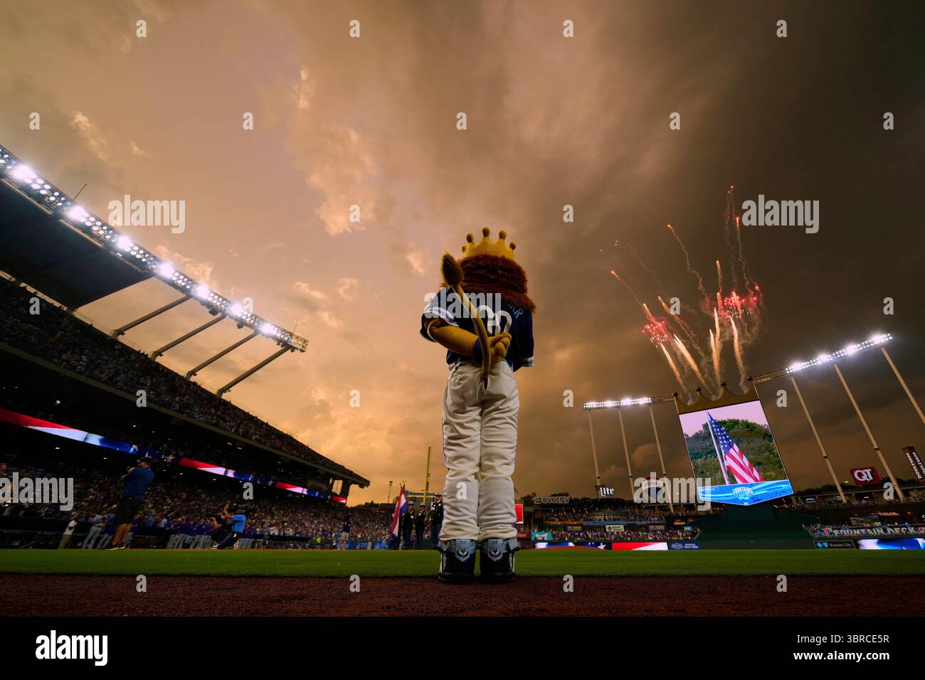 Kansas City Royals mascot Sluggerrr stands for the national anthem ...