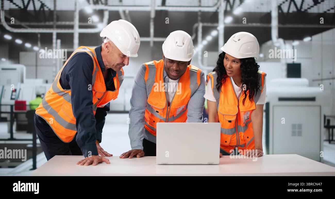 Inspecting Automated Manufacturing Process In Factory. Diverse Team ...