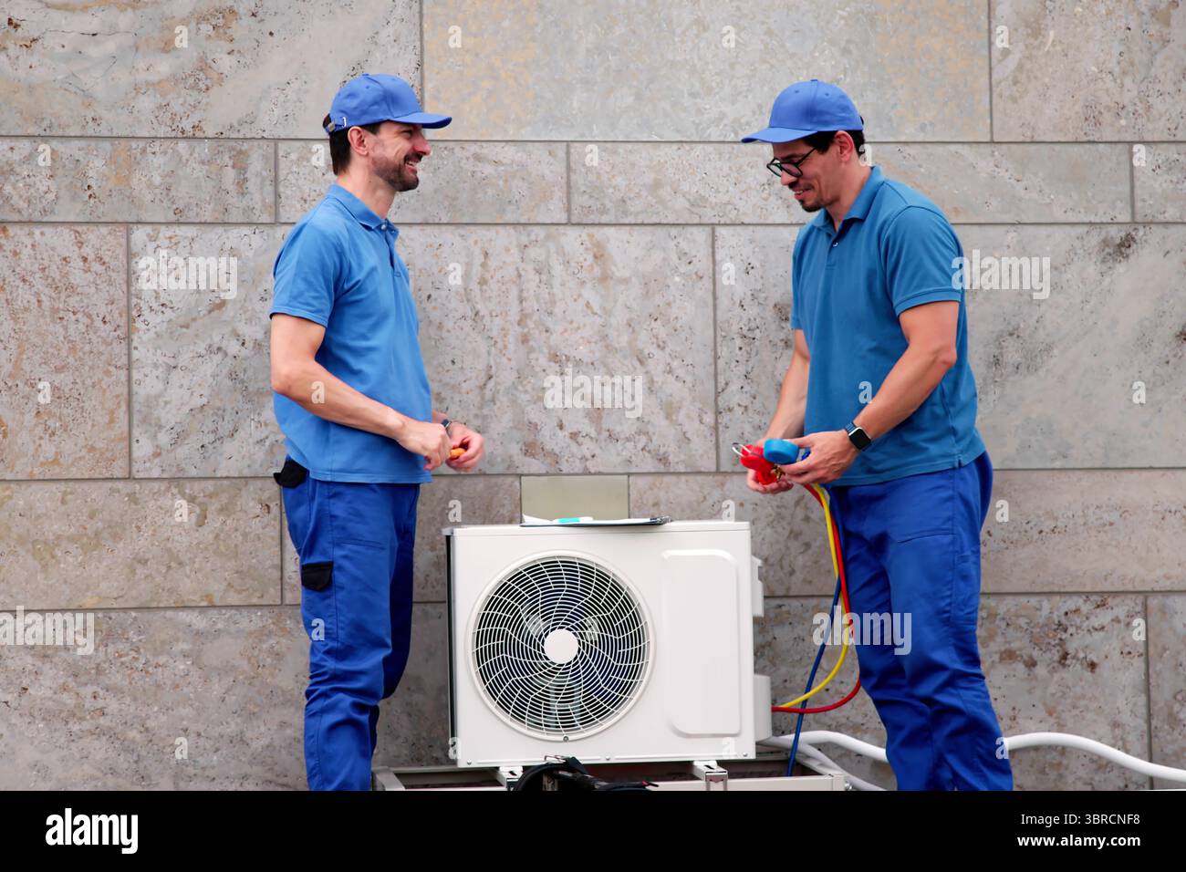 Male technician repairs air conditioner hi-res stock photography and images - Alamy