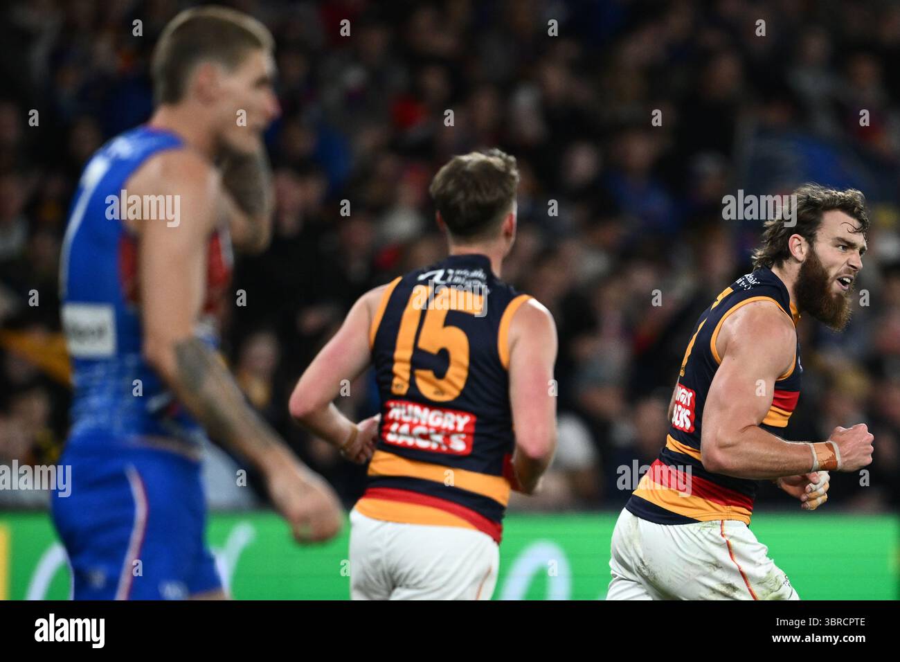Riley Thilthorpe of the Crows (right) celebrates scoring a goal during ...