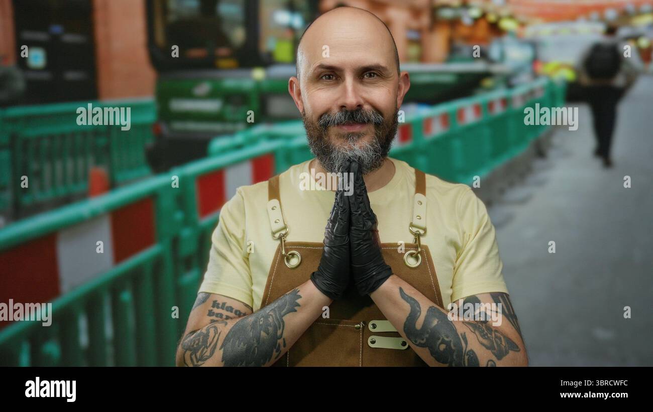 Bald man gloves tattoos stands hi-res stock photography and images - Alamy