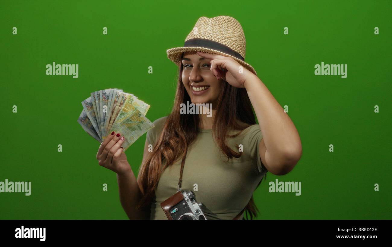 Woman with camera and peruvian soles joyfully poses against a vibrant ...