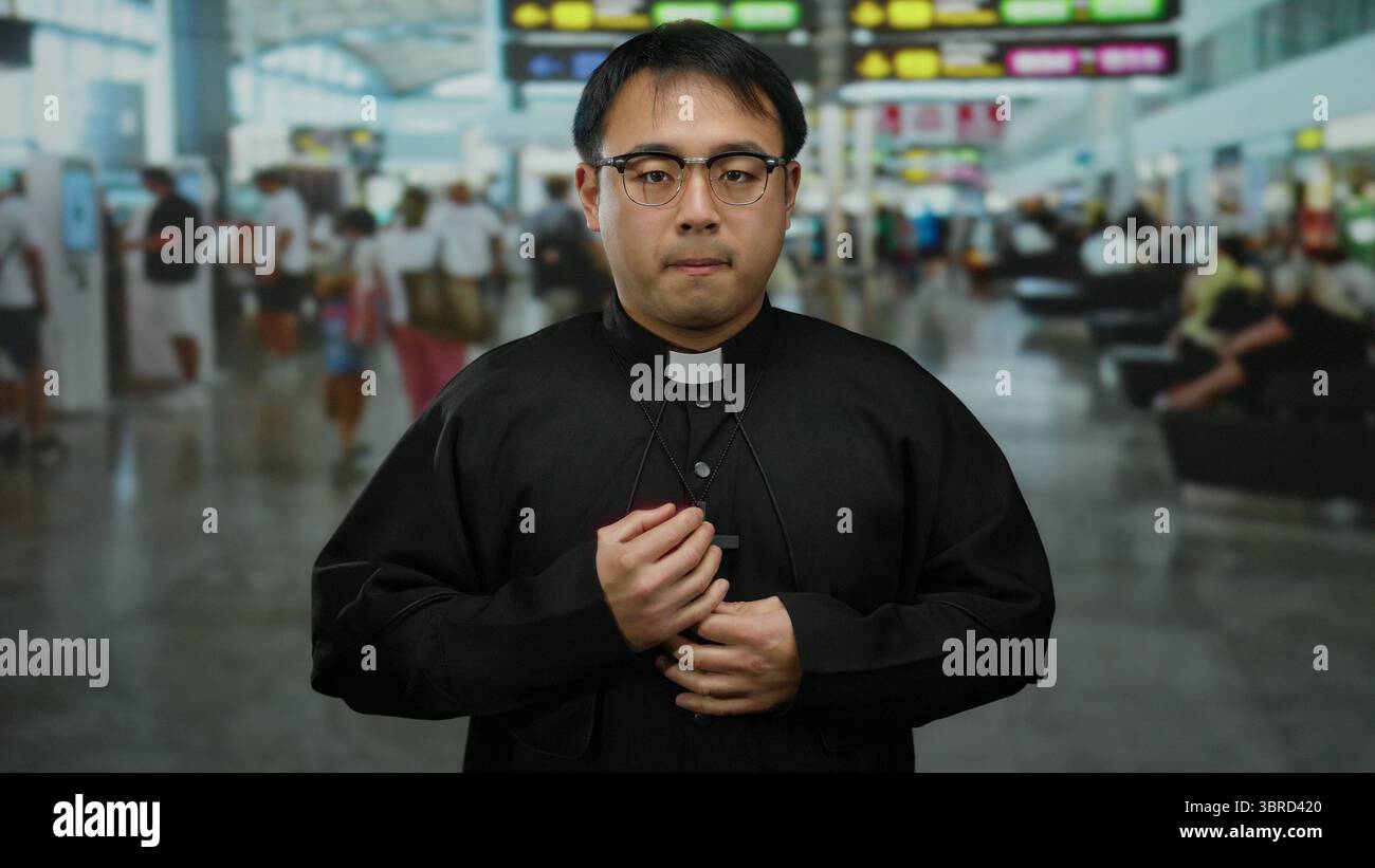 Chinese priest in a bustling airport terminal displaying a worried ...