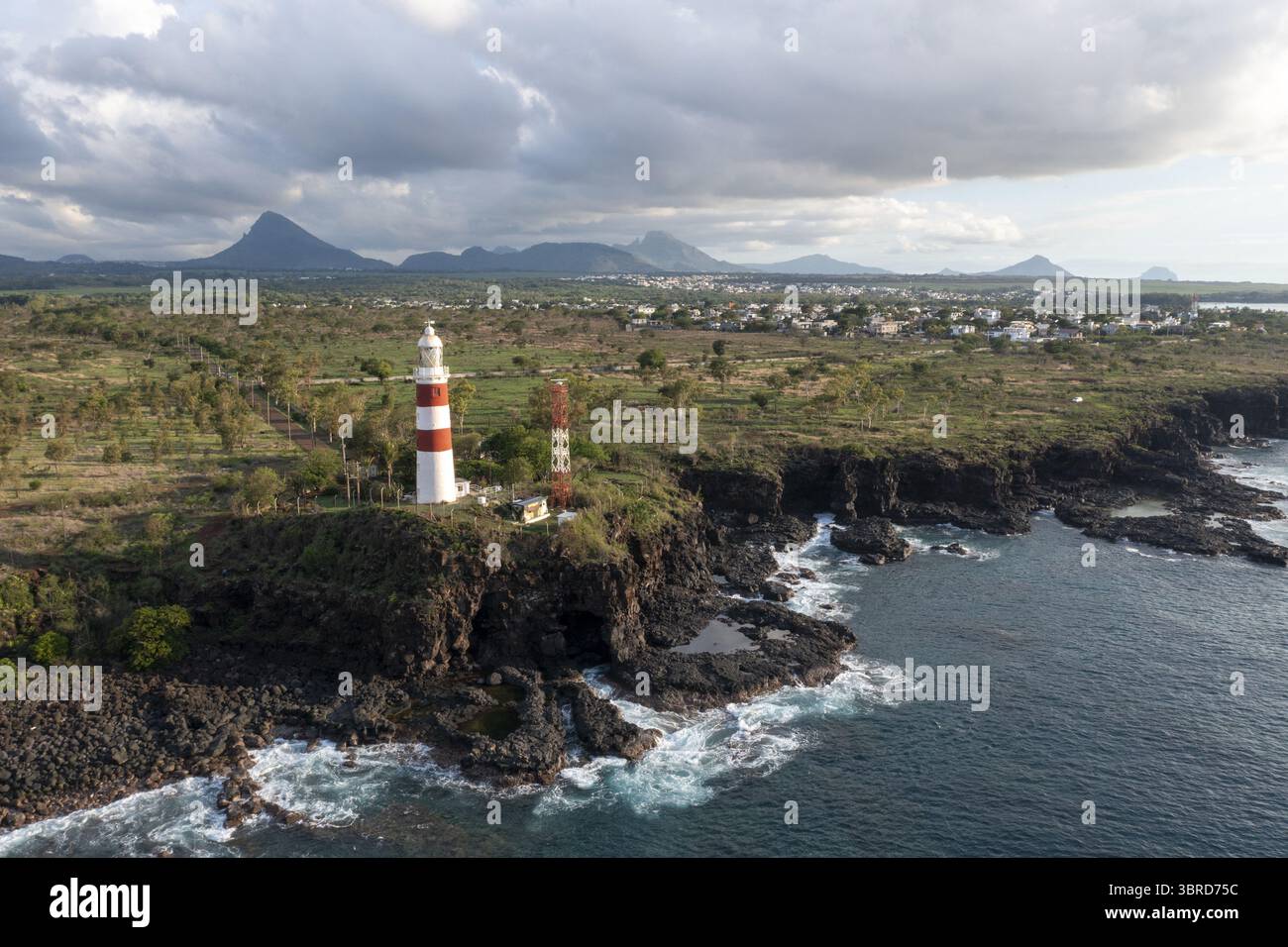Aerial view of a striking red and white lighthouse standing tall on the ...