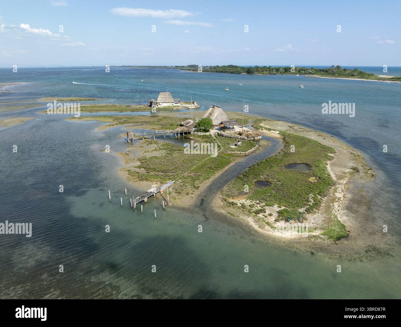 Aerial view of rustic thatched structures nestled on an island ...
