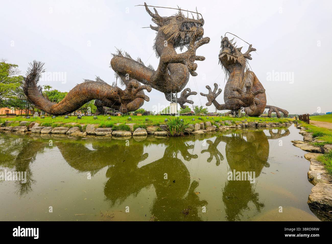 A pair of dragon sculptures that look like real dragons on a small ...