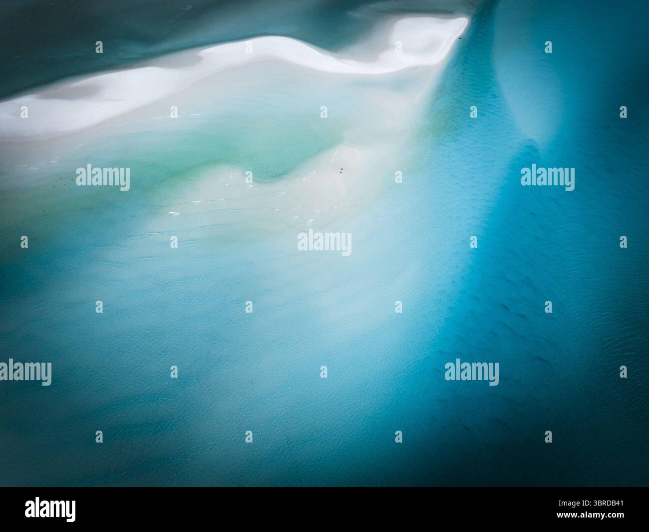 Aerial view of the swirling turquoise waters meeting the pure white ...