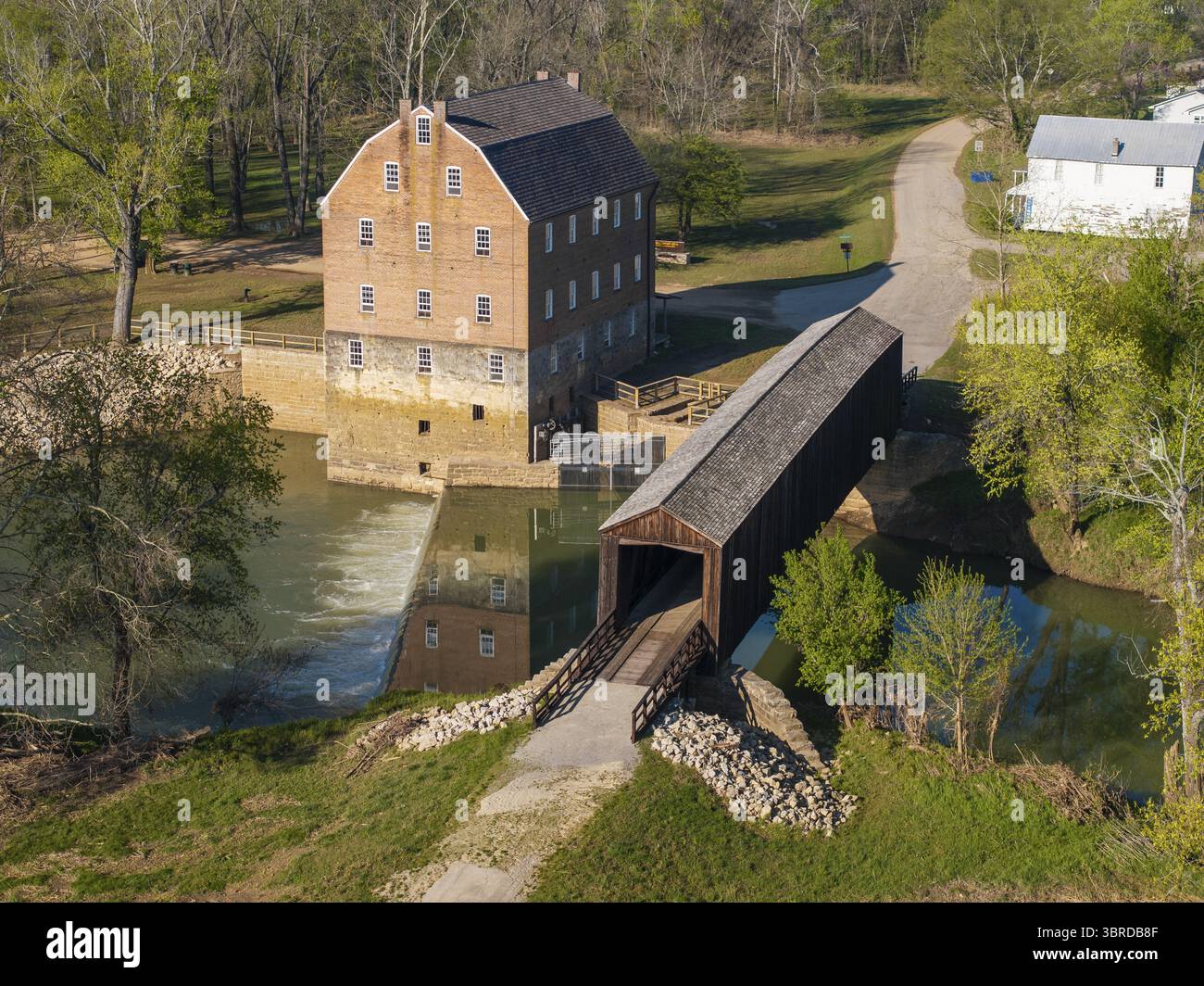 Aerial view of a historic mill reflecting in the serene waters ...